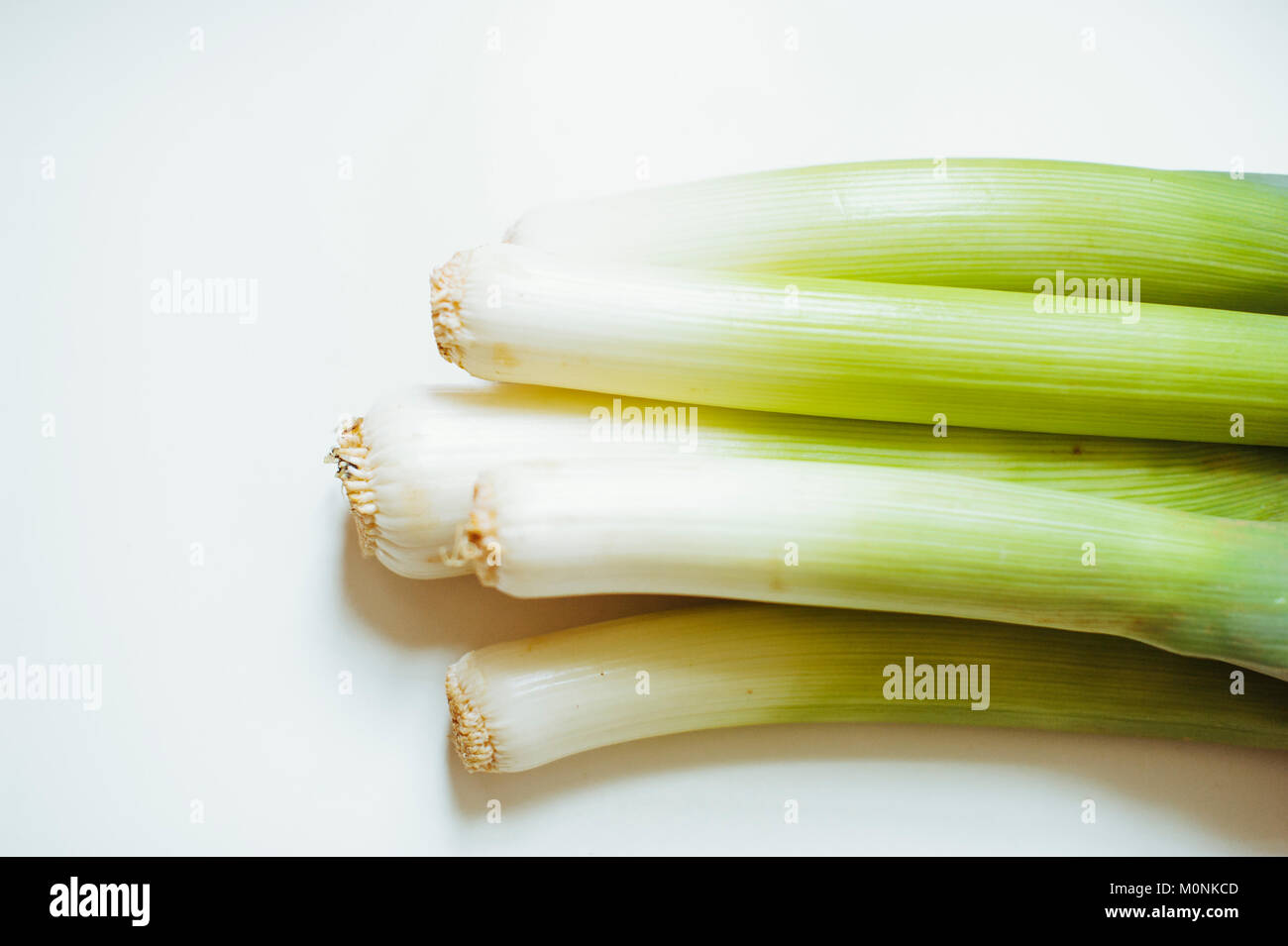 still life of vegetable leeks on white background Stock Photo - Alamy