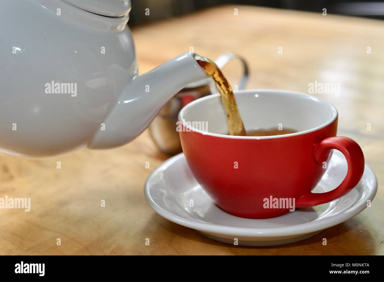 Tea Being Poured Into A Tea Cup Stock Photos & Tea Being Poured Into A ...