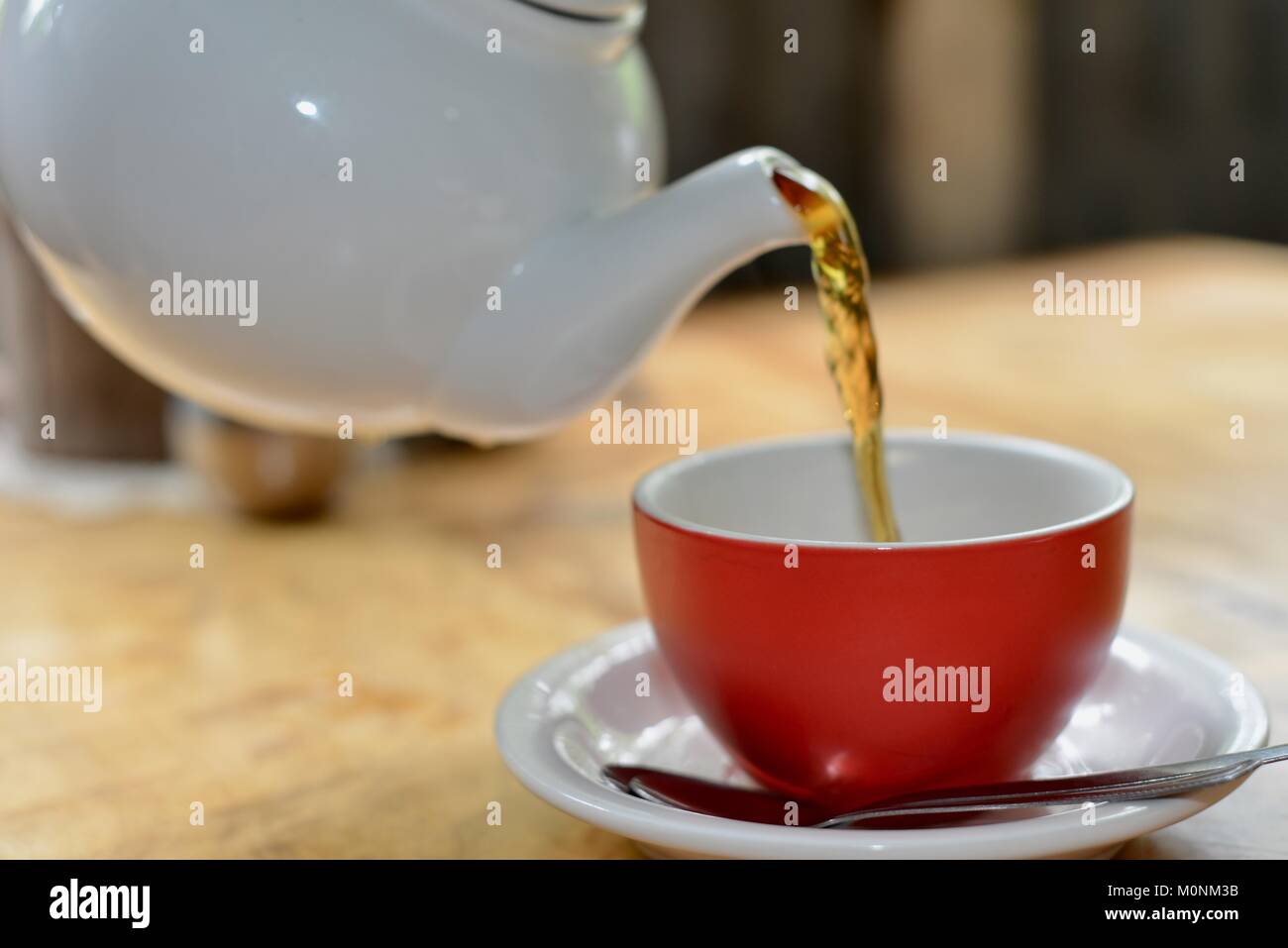 Tea Being Poured Into A Tea Cup Stock Photos & Tea Being Poured Into A ...