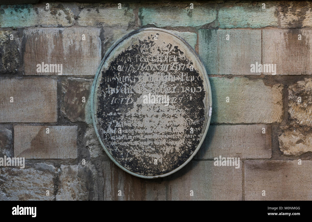 Plaque on the limestone wall of St George’s Church, Stamford ...