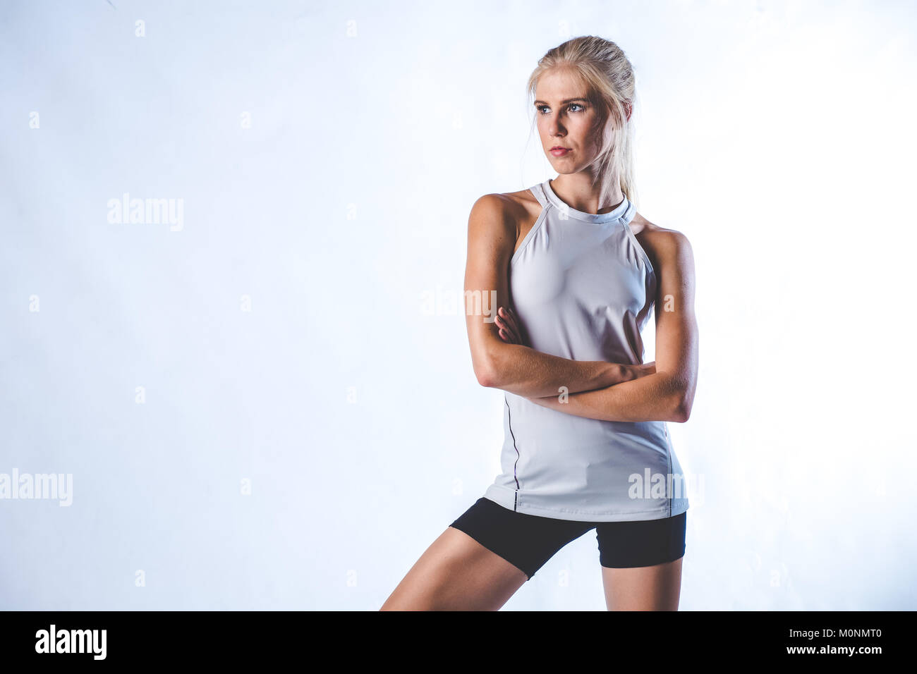 Beautiful female fitness model doing stretches and dancing in a studio ...