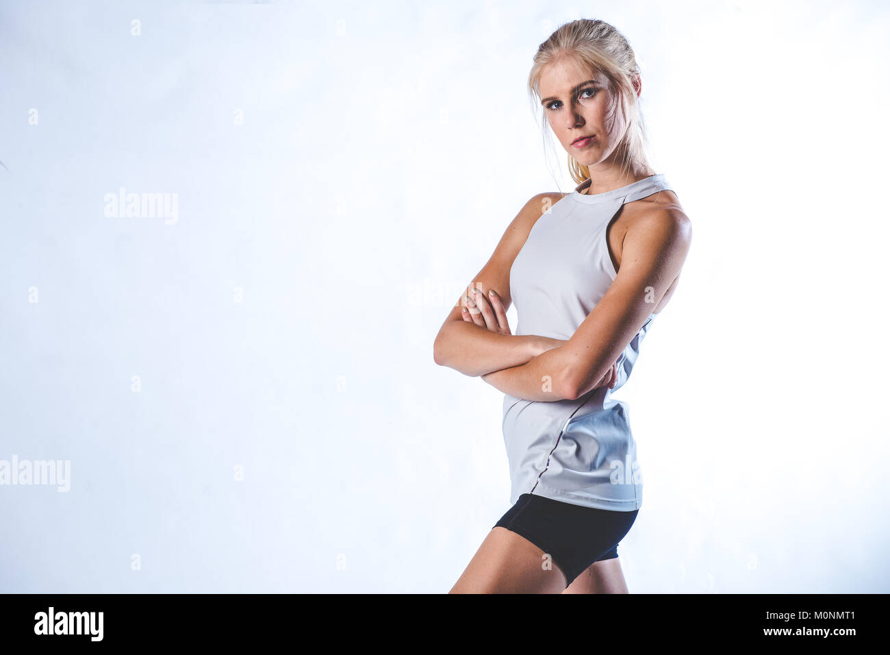 Beautiful female fitness model doing stretches and dancing in a studio ...