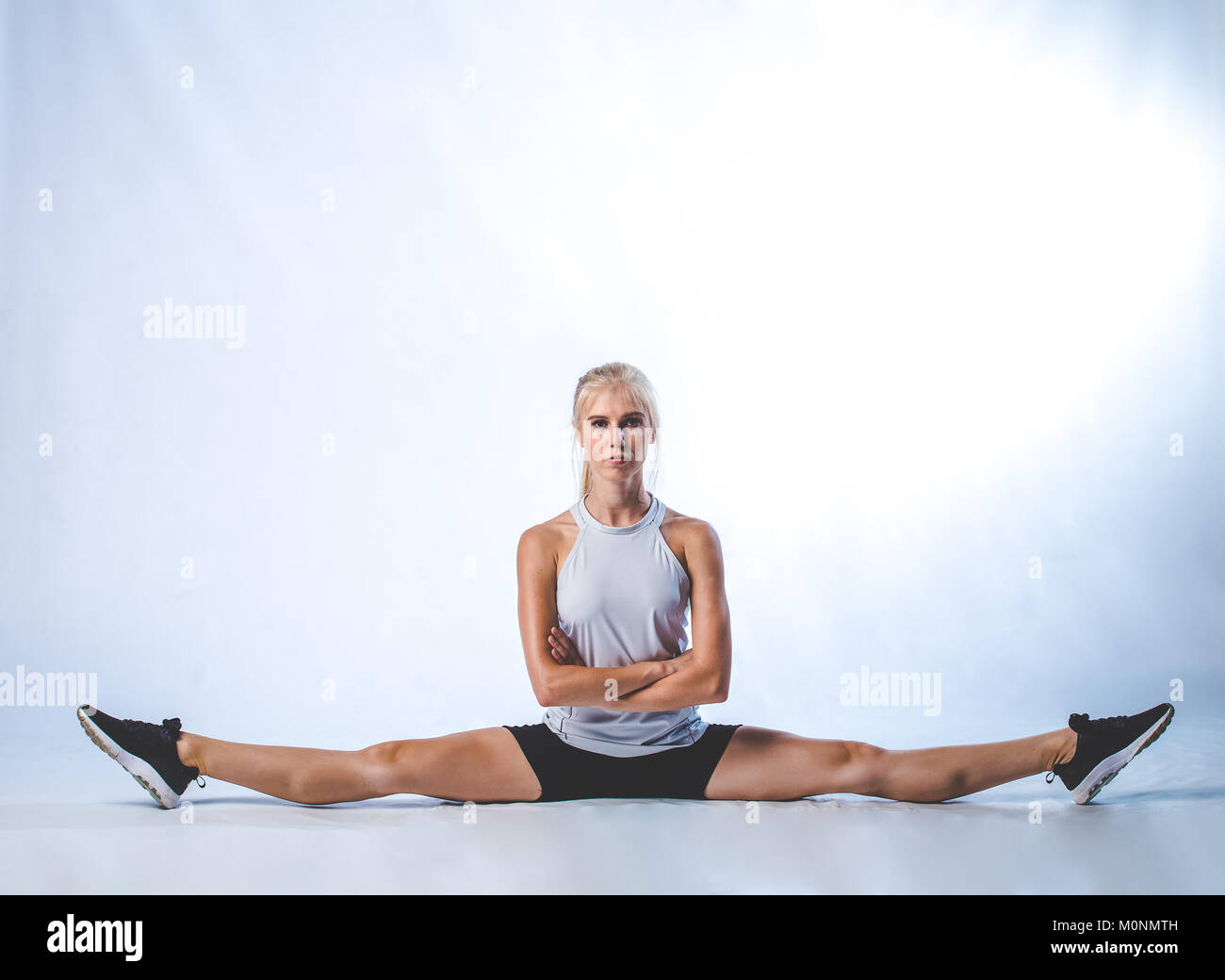 Beautiful female fitness model doing stretches and dancing in a studio ...