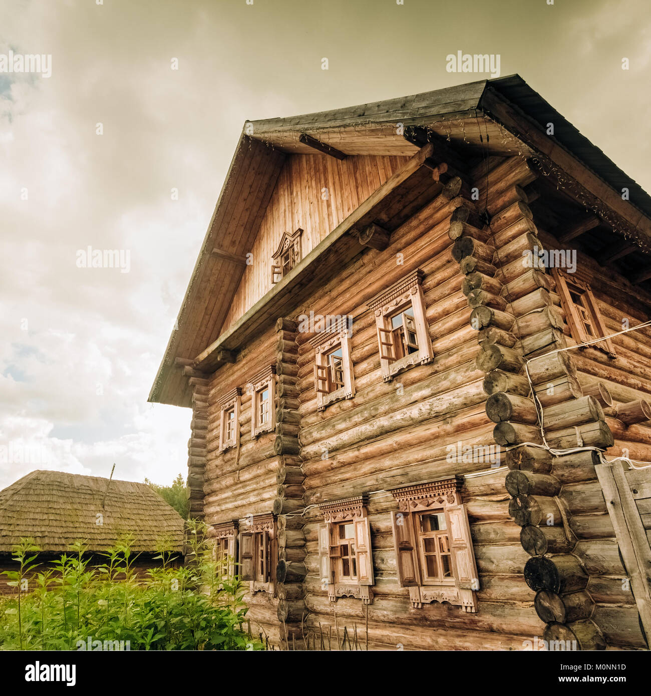 Wooden two-story log house Slavic type Stock Photo - Alamy