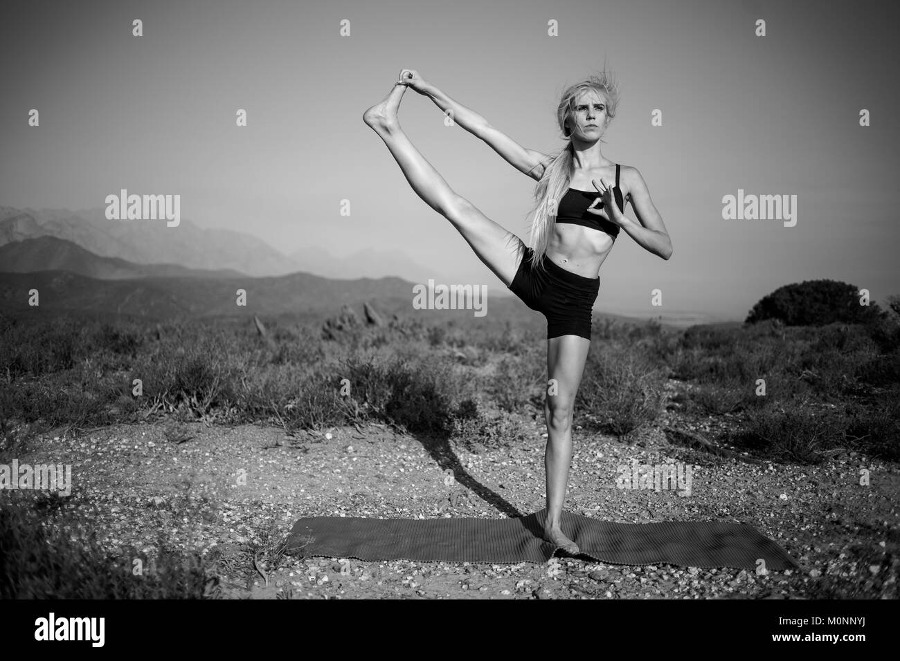 Female model practicing yoga in the outdoors doing stretching and ...