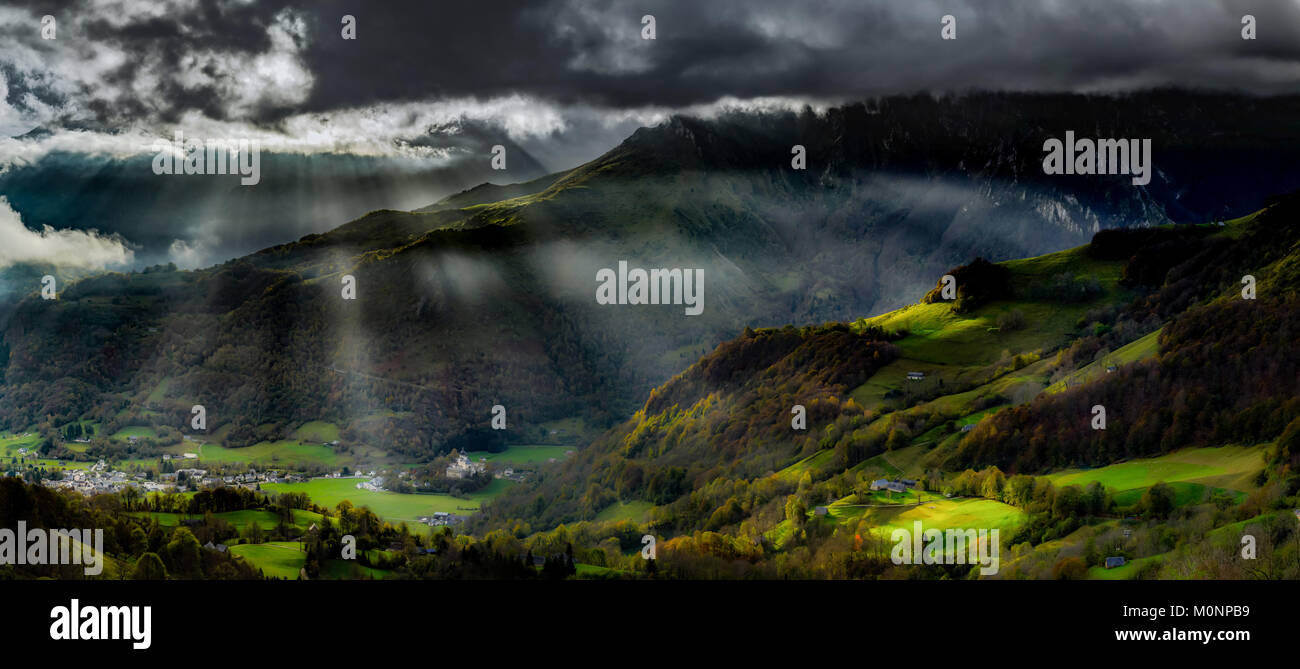 Sun rays lighting through the clouds in high Pyrenees, sunrise, green ...