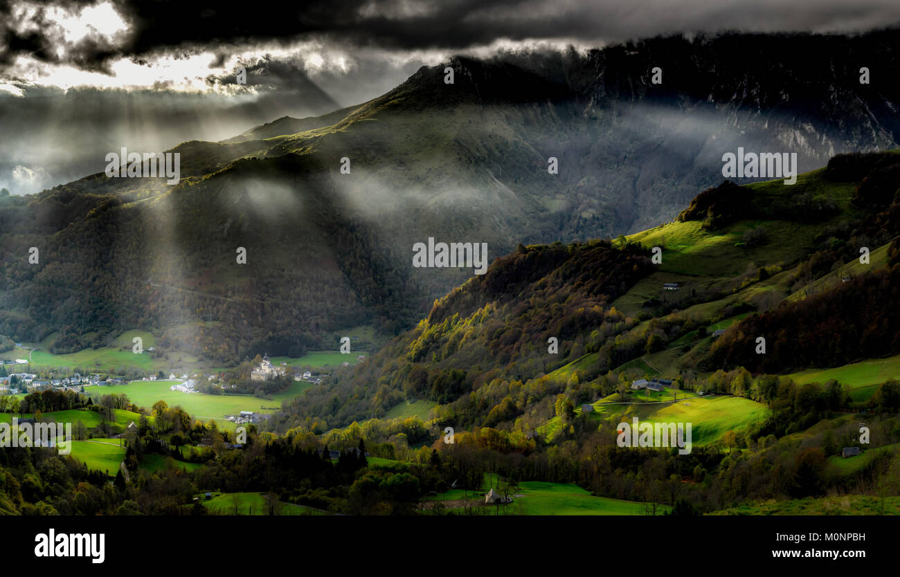 Sun rays lighting through the clouds in high Pyrenees, sunrise, green ...