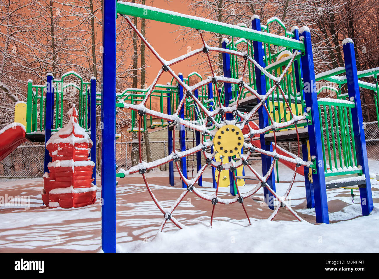 Children's playground under the snow at sunset Stock Photo - Alamy