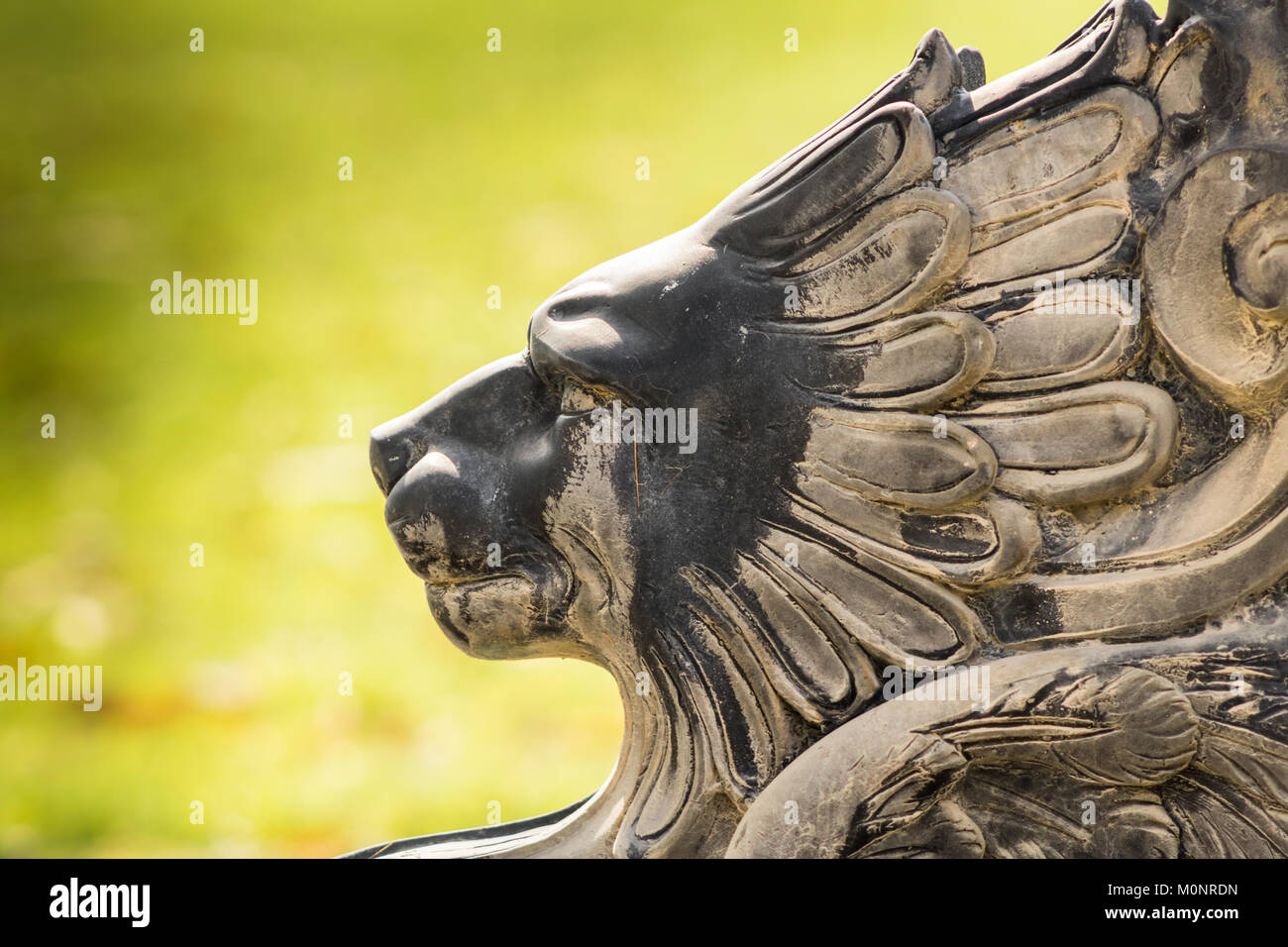 A statue of a lion that seems to be crying after gazing at something ...