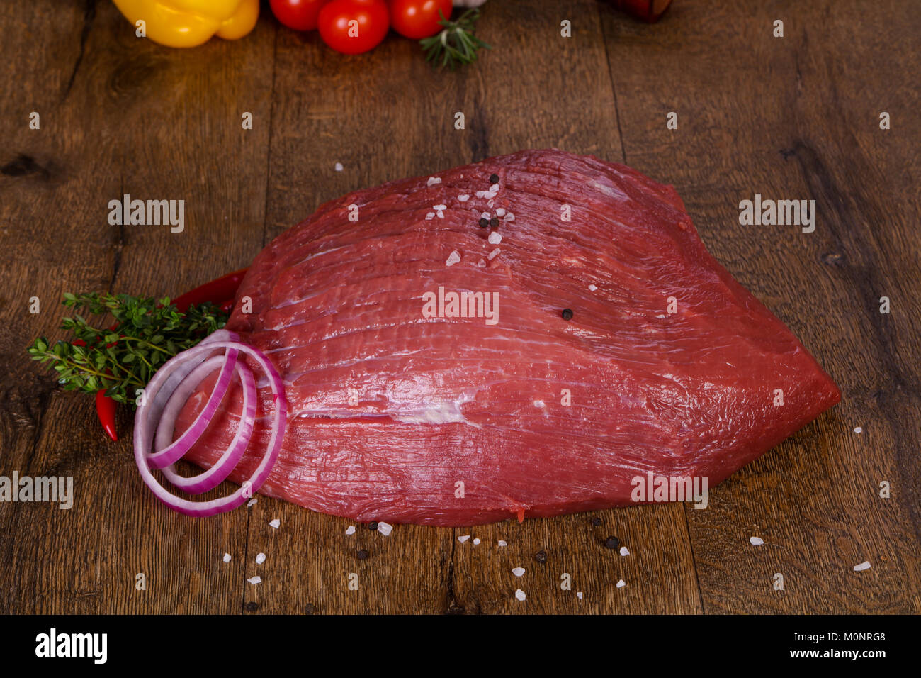 Raw beef meat over the wooden background Stock Photo - Alamy