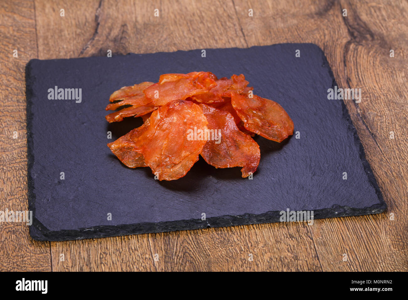 Dry chicken meat over wooden Stock Photo - Alamy