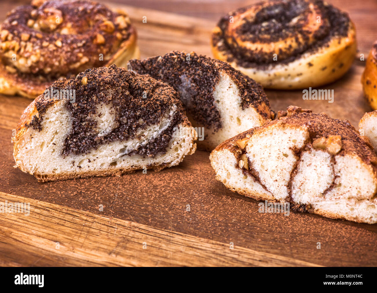 Round buns with poppy seeds and cinnamon cut in half, vintage toning ...