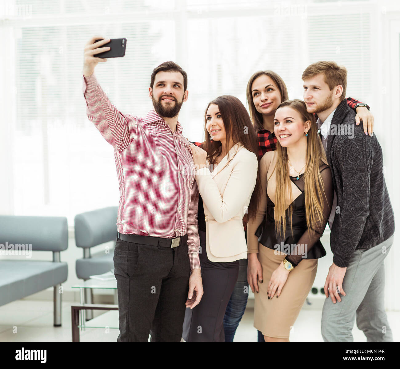 professional business team making selfie while standing near window in ...