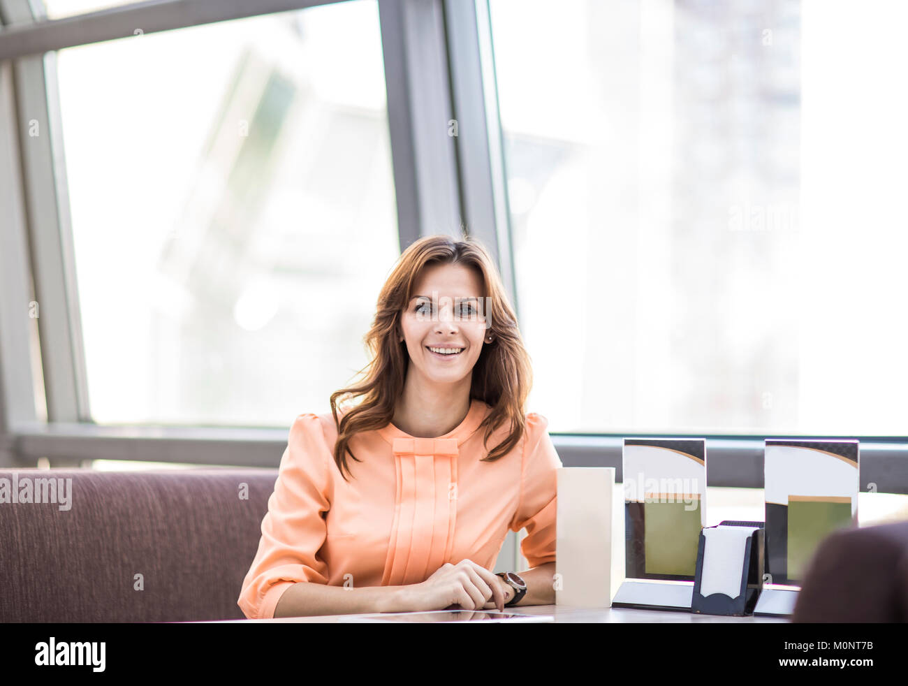 successful business woman sitting at Desk in office Stock Photo - Alamy