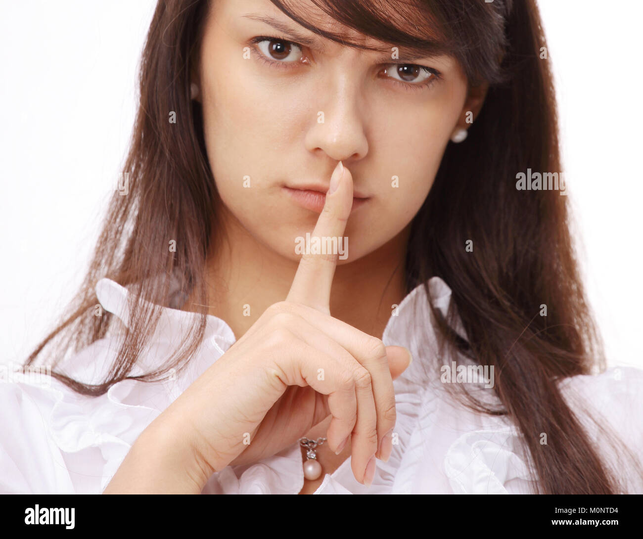 young serious business woman ,putting a finger to her lips Stock Photo ...