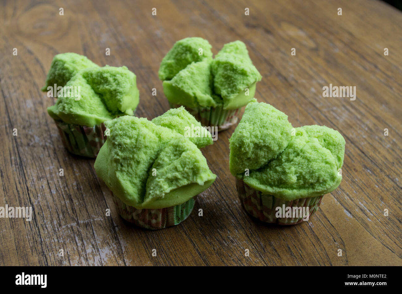 Typical Indonesian sweets green bolu kukus on table next to each other ...