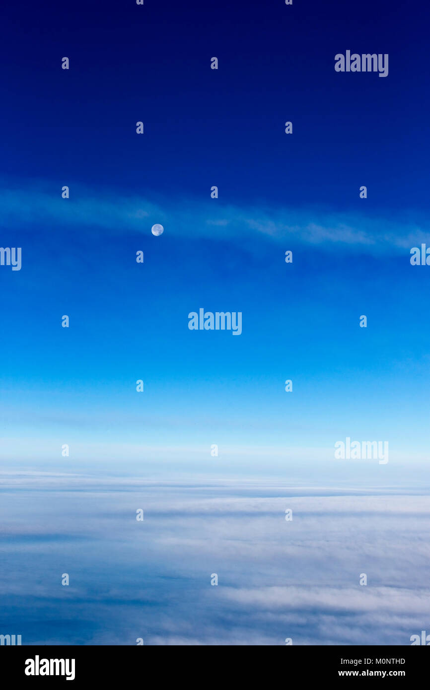 Skyscape, in-flight shot of the early morning sky with the Moon Stock ...