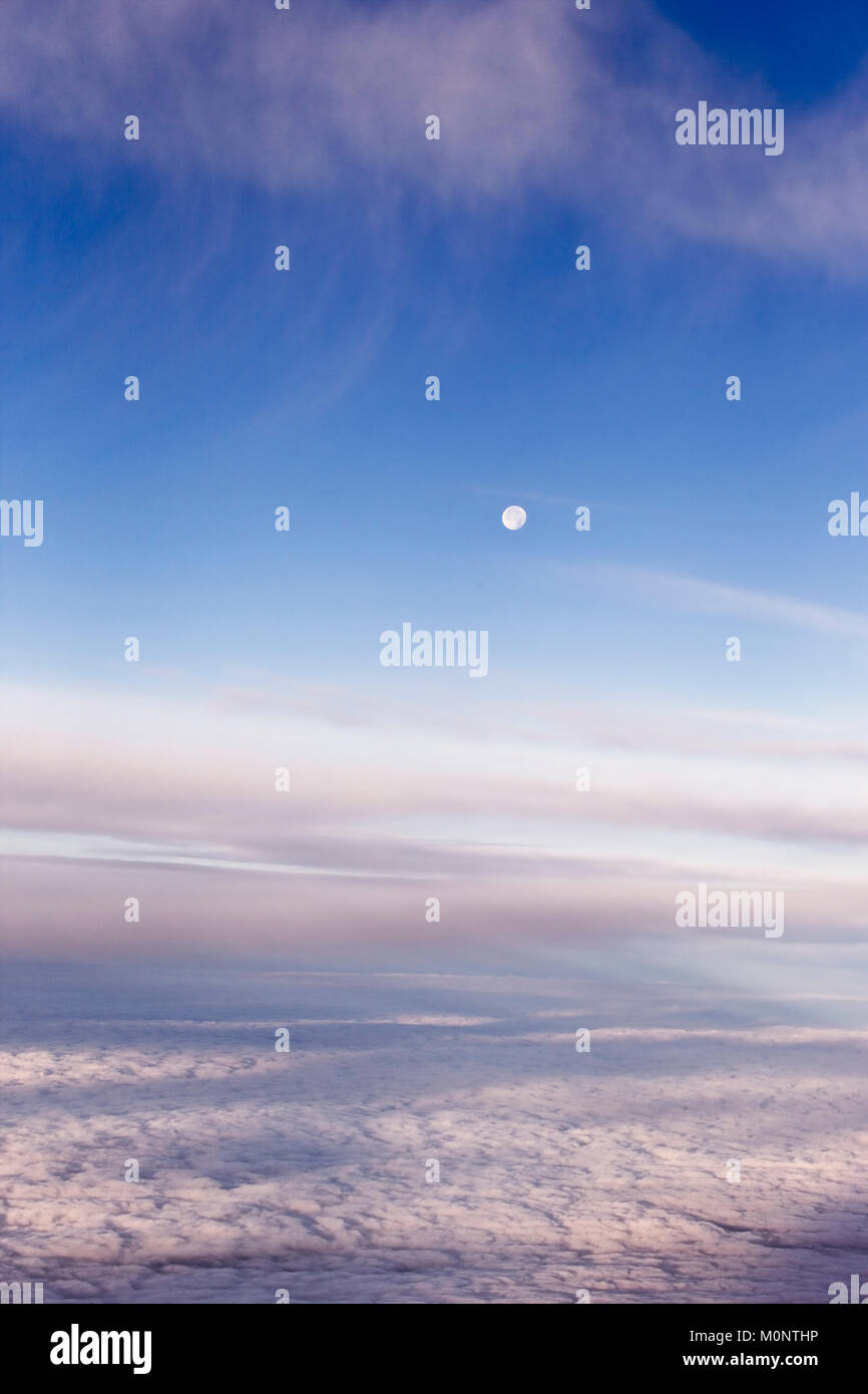 Skyscape, in-flight shot of the early morning sky with the Moon Stock ...
