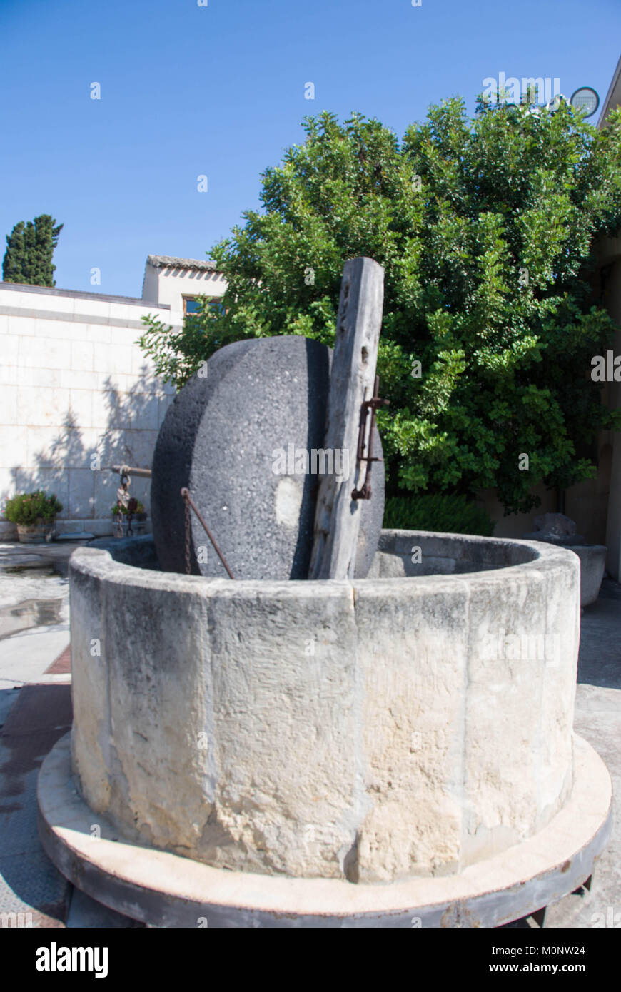 An old stone crusher for olives Stock Photo - Alamy