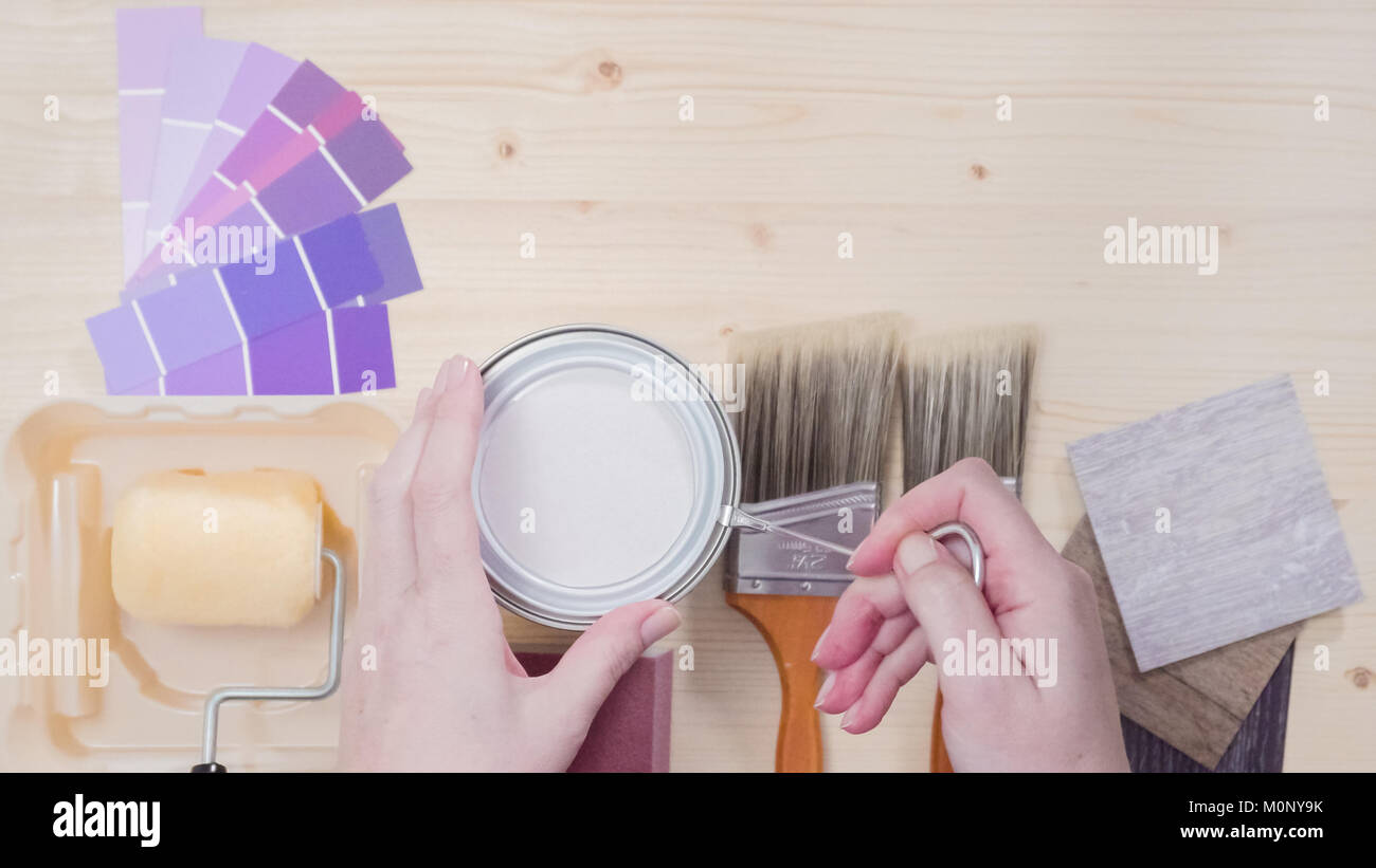 Opening metal paint can with purple interior paint Stock Photo - Alamy