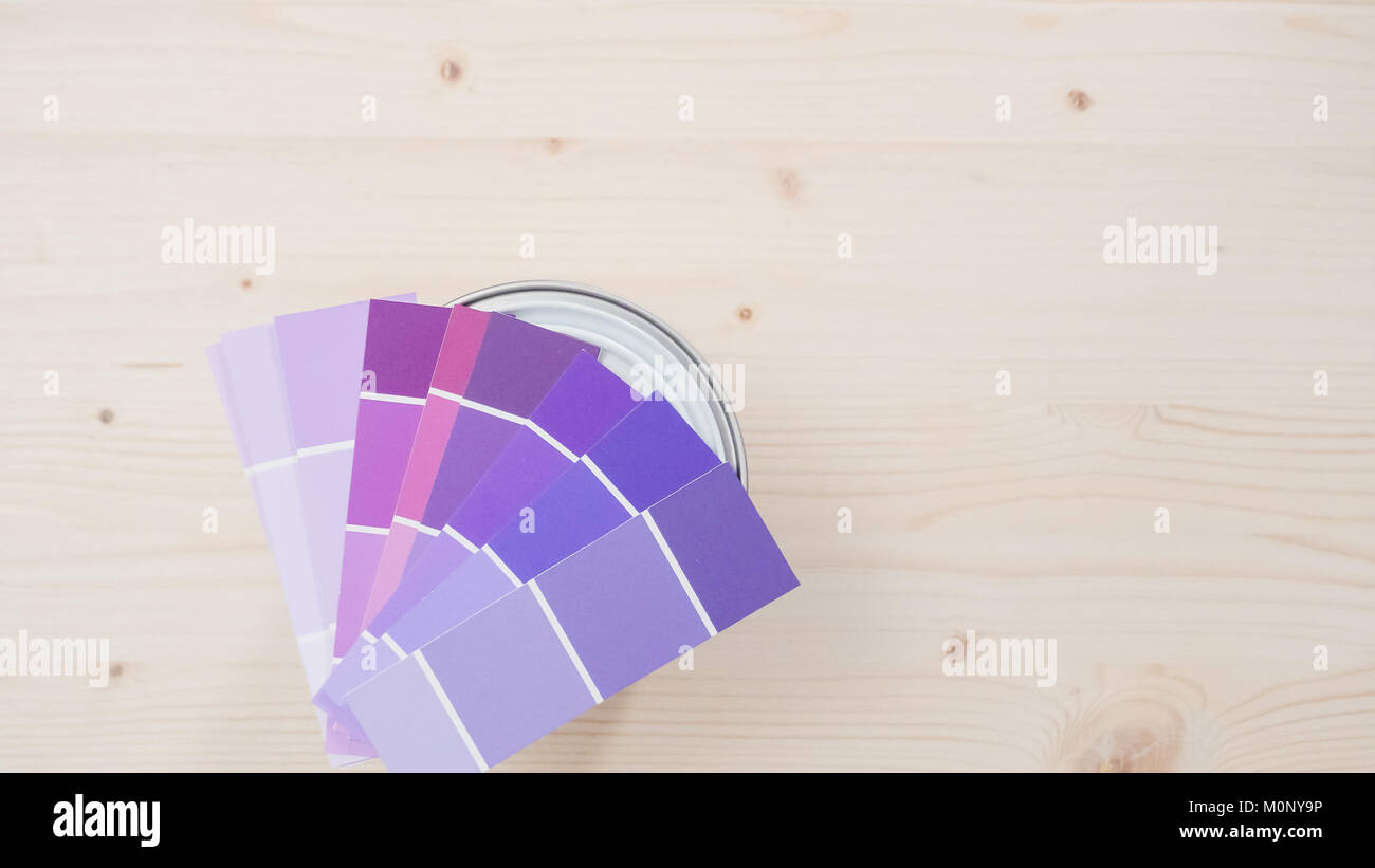 Variety of paint swatches with shades of purple pain on unfinished ...