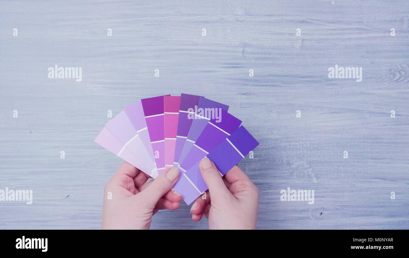 variety of paint swatches with shades of purple pain on painted wooden ...