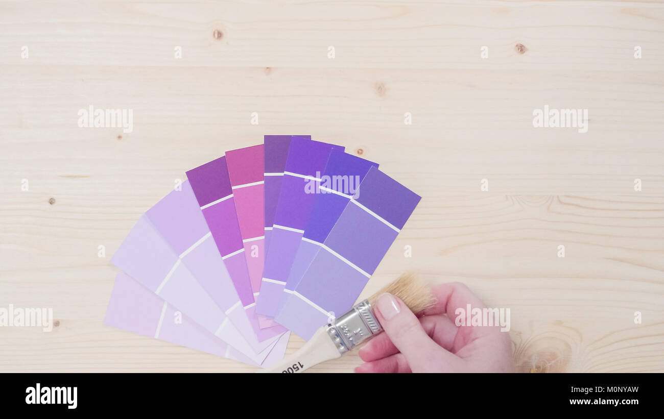 Variety of paint swatches with shades of purple pain on unfinished ...
