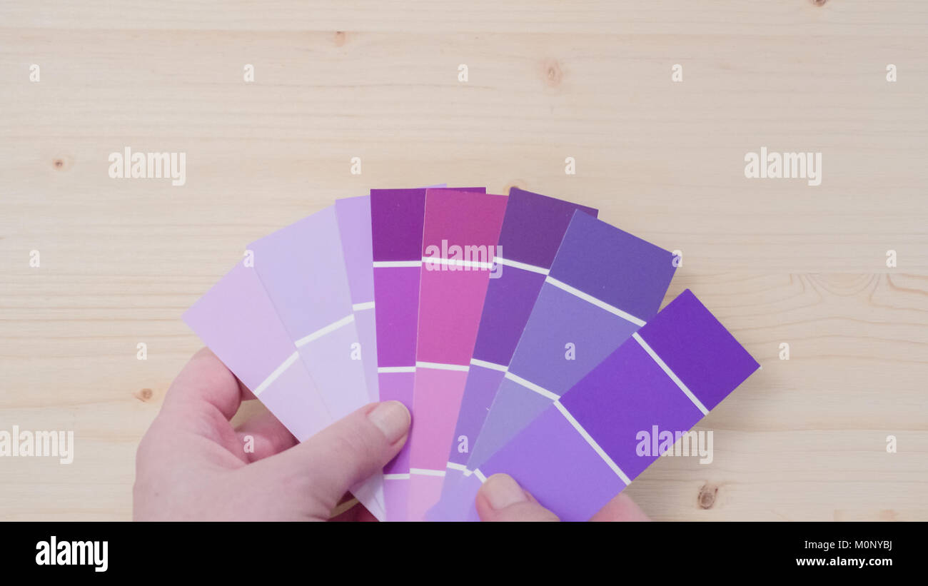 Variety of paint swatches with shades of purple pain on unfinished ...