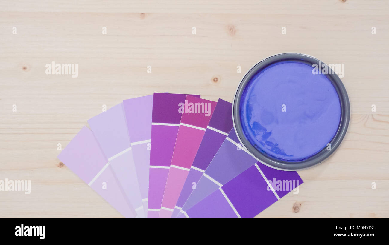 Variety of paint swatches with shades of purple pain on unfinished ...