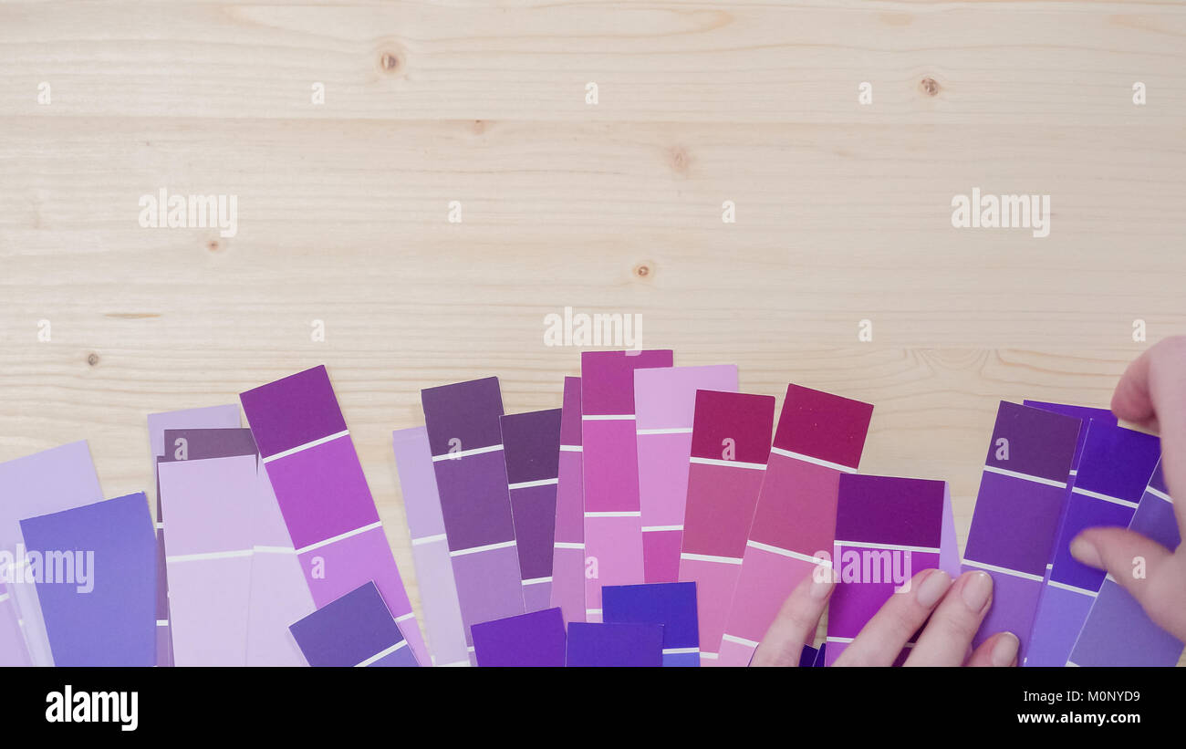 Variety of paint swatches with shades of purple pain on unfinished ...