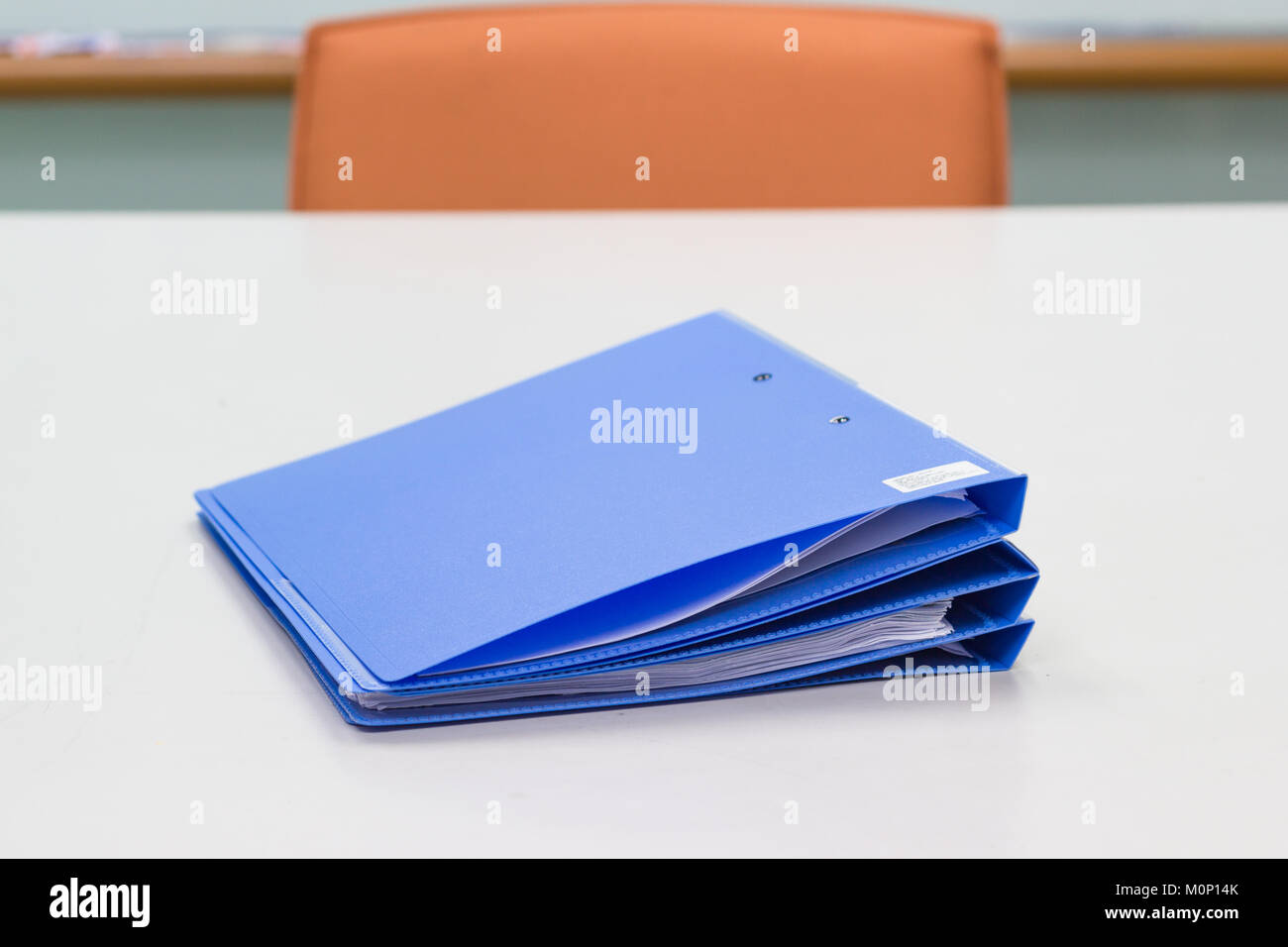 Blue File folder with Documents on white table in meeting room ...