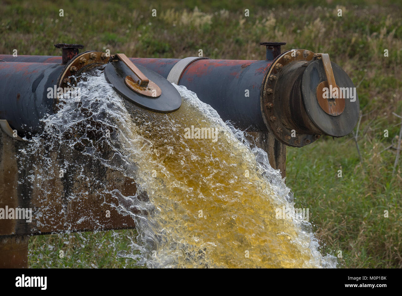 Waste water flowing out of a pipe Stock Photo - Alamy
