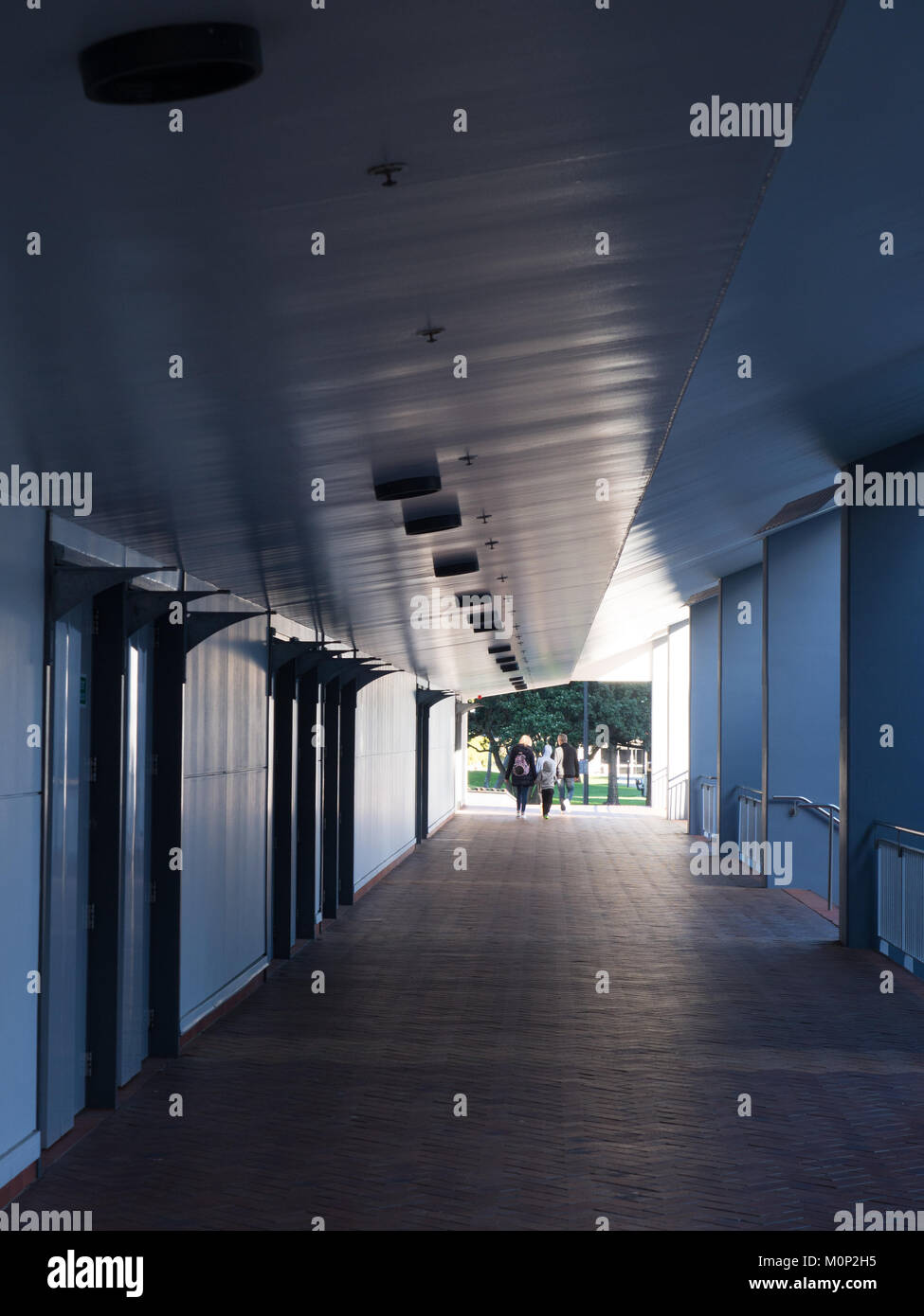 People Walking Through A Corridor Stock Photo - Alamy