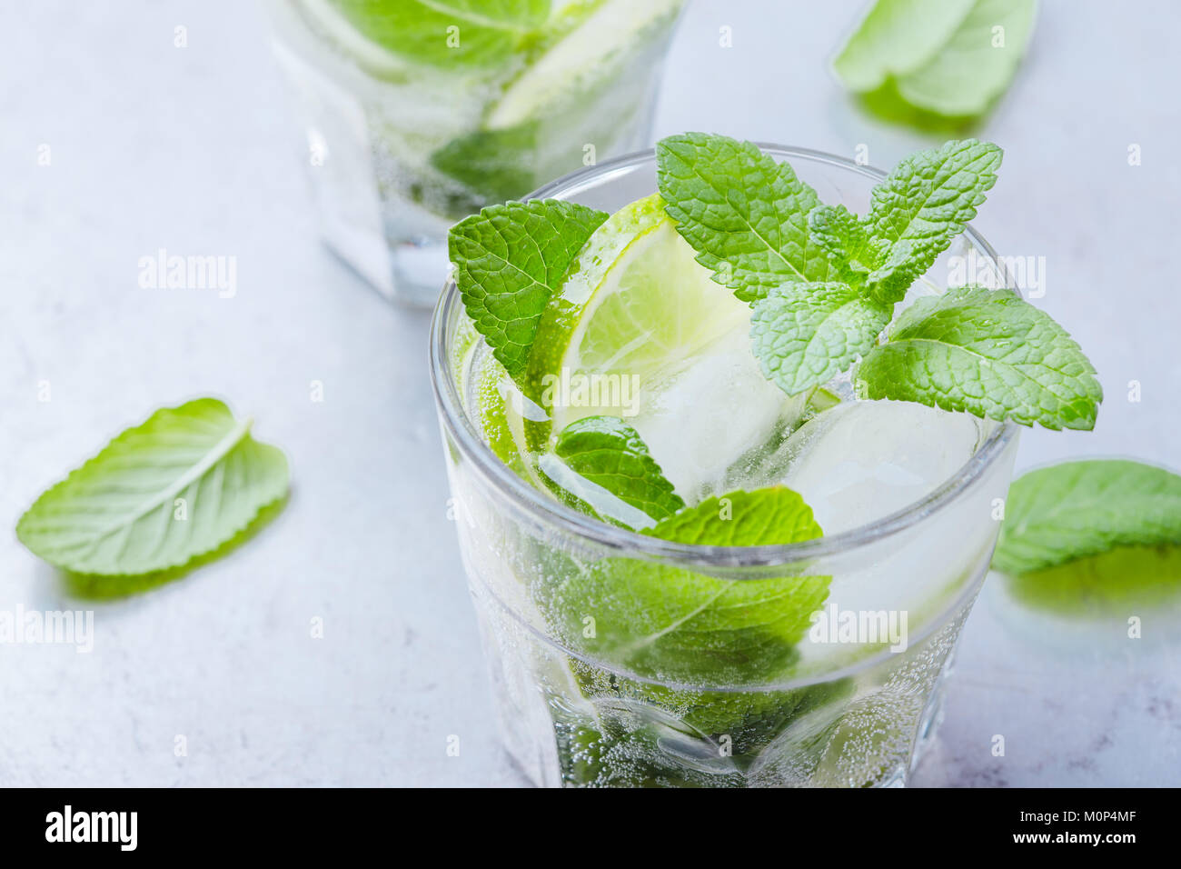 Mojito cocktail, refreshing summer drink in chilled glasses on light ...