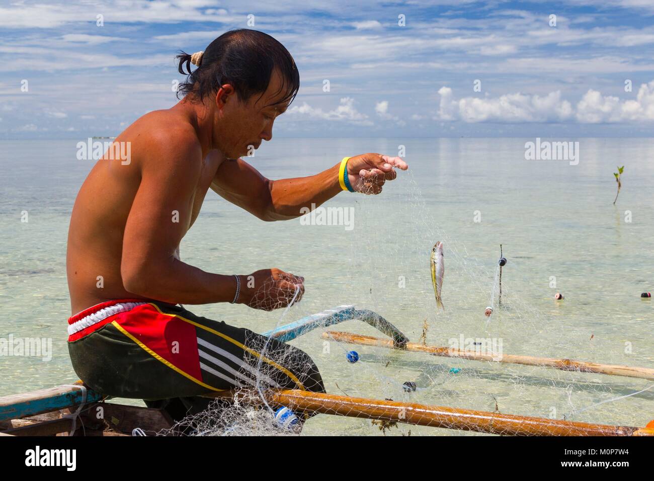 Philippines,Palawan,Roxas,Green Island Bay,Purao Island,man fishing in ...
