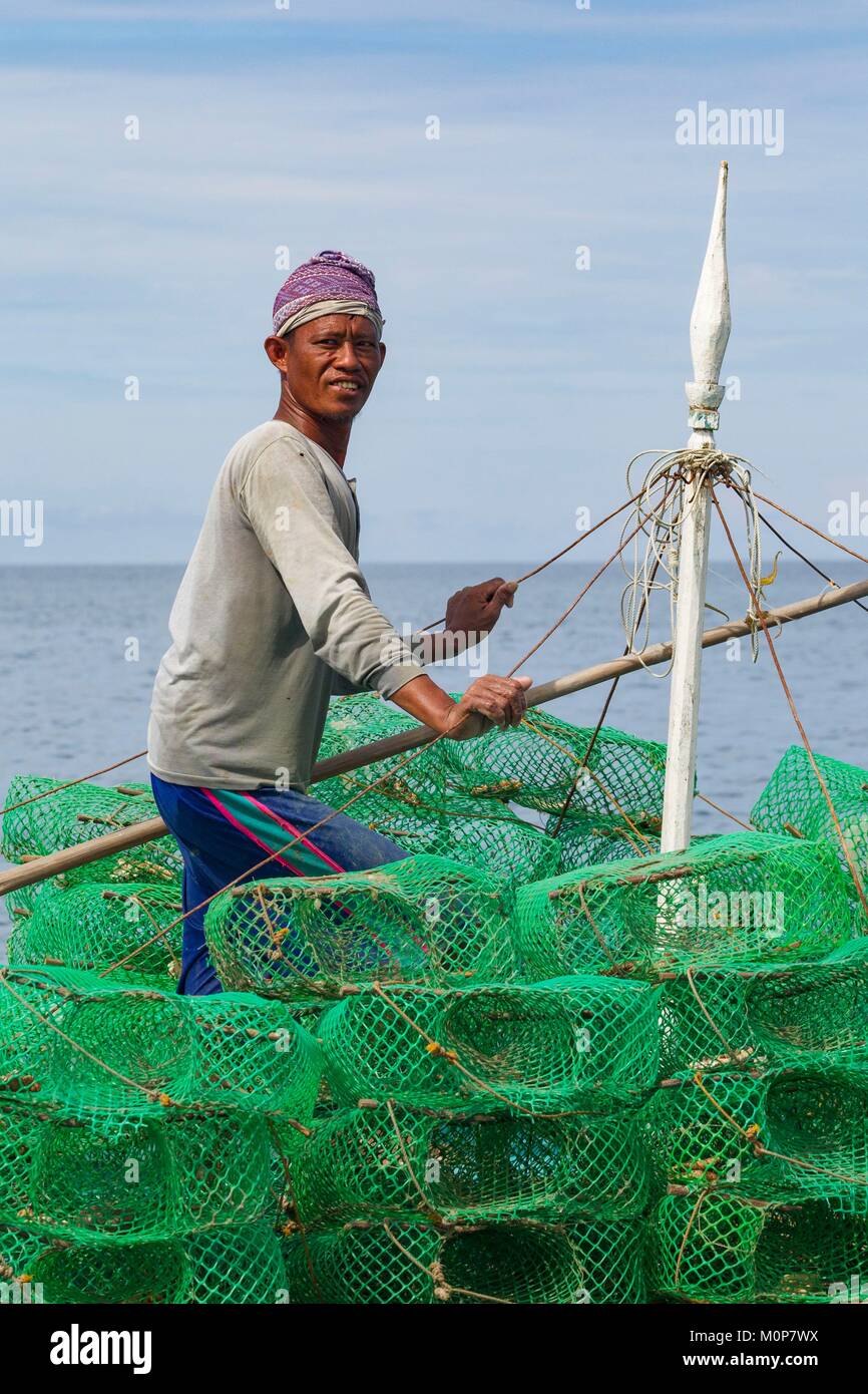 Philippines,Palawan,Roxas,Green Island Bay,fisherman carrying fish ...