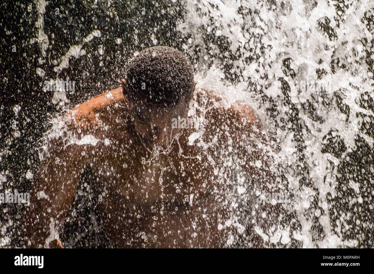 Man bathing under waterfall hi-res stock photography and images - Alamy