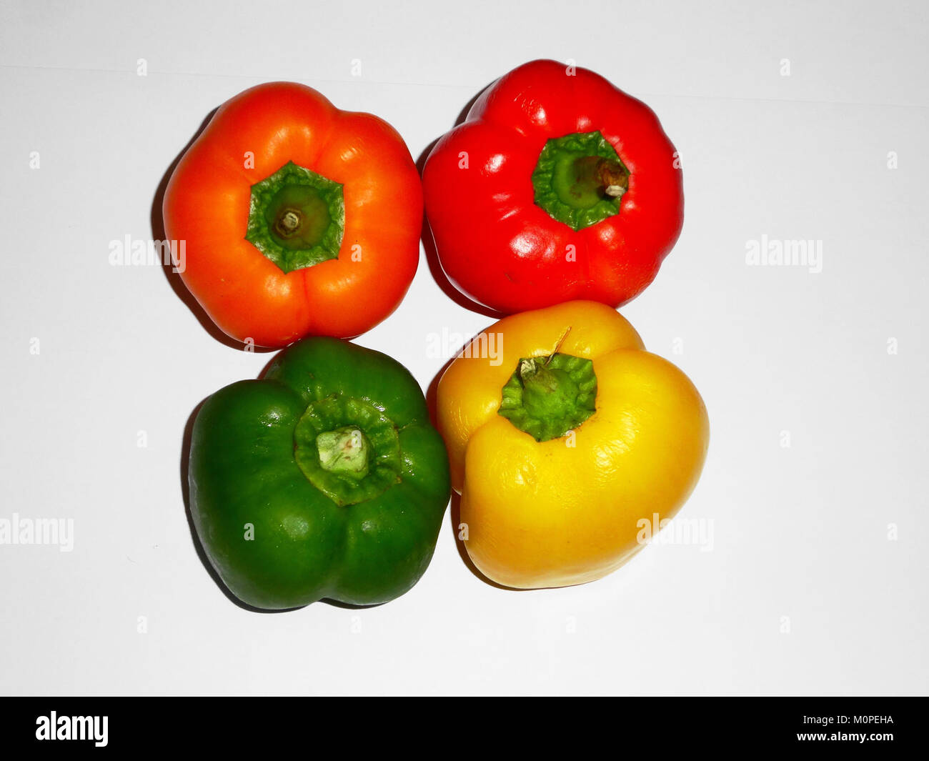 This image depicts four different colored varieties of Capsicum ...