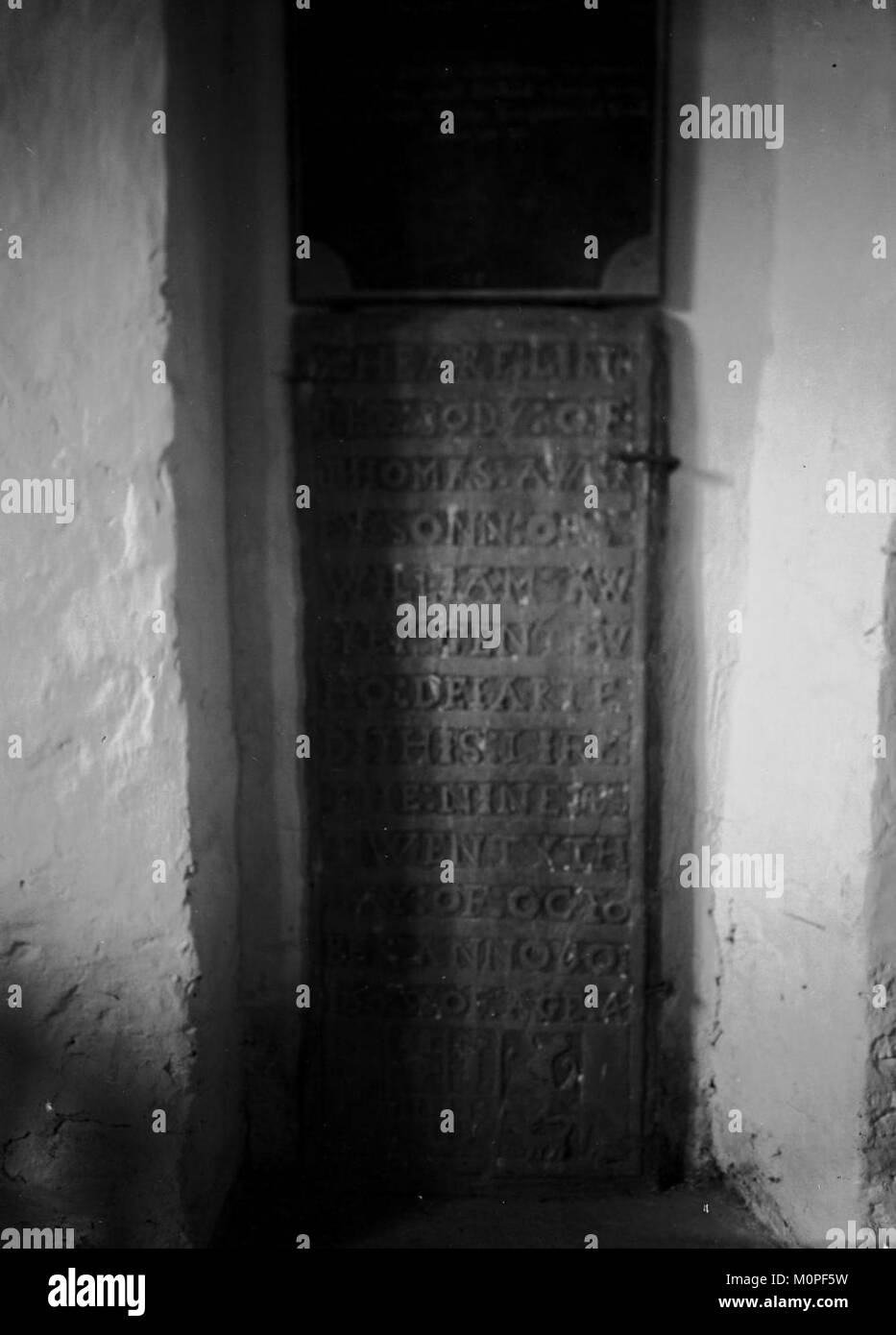 The carved dedication on stone is a historical artifact, likely ...