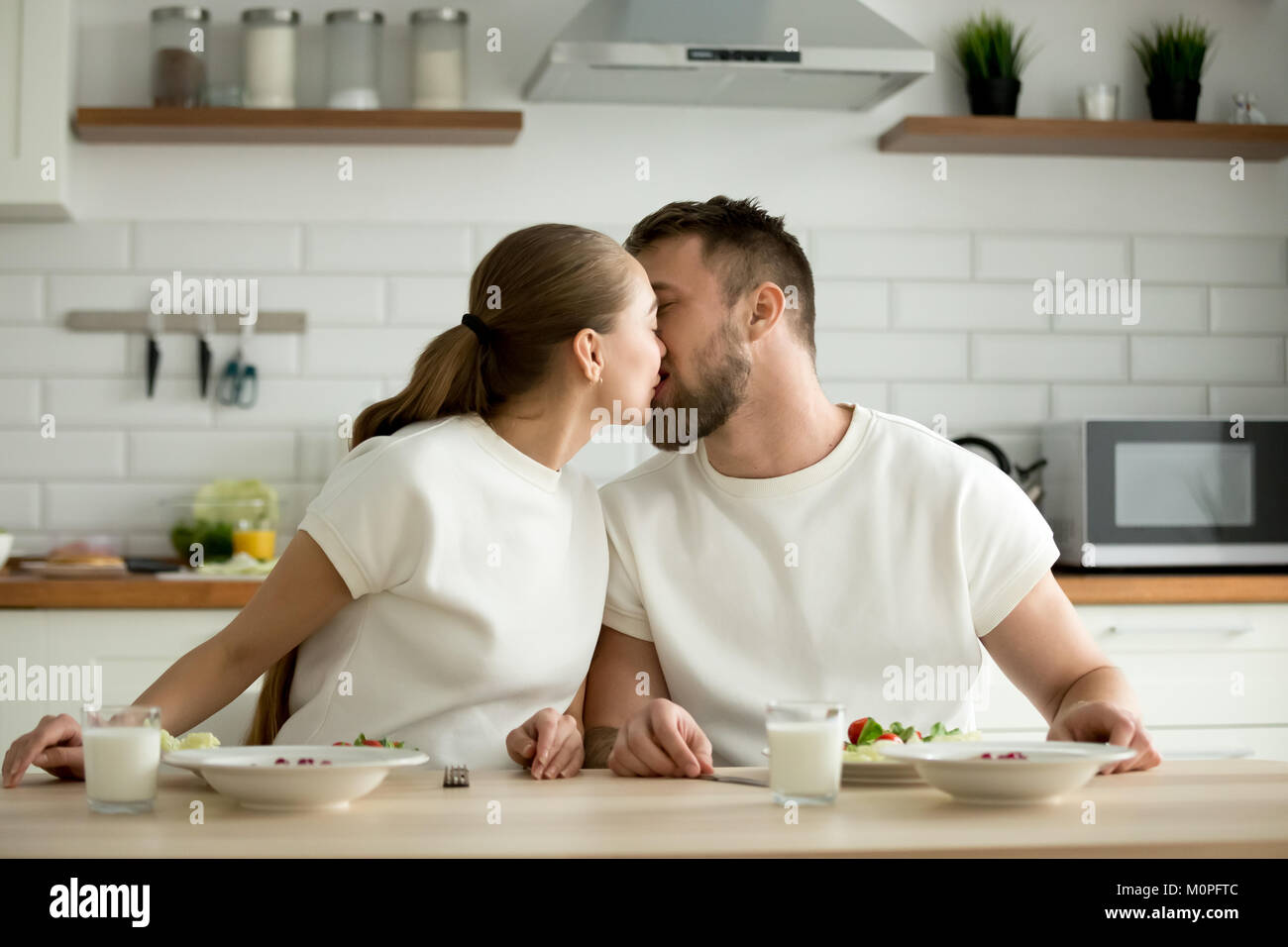Couple kissing dinner table hi-res stock photography and images - Alamy