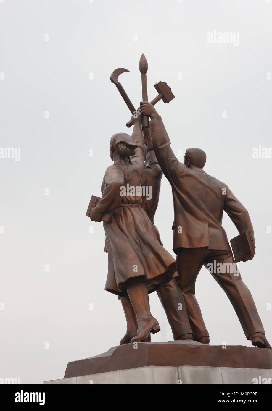 Statues at the bottom of the Juche tower built to commemorate Kim il ...