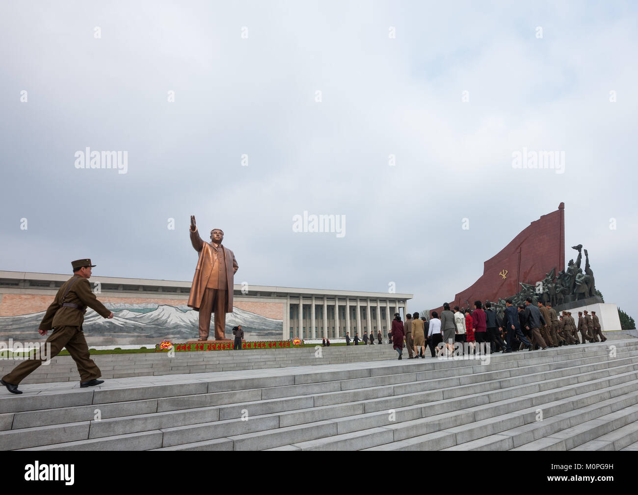 Soldiers passing by statue of Kim il Sung in the Grand monument on ...