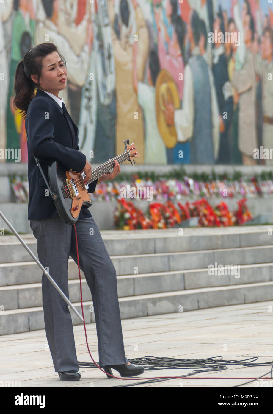 North Korean state artist playing bass on national day, Pyongan ...