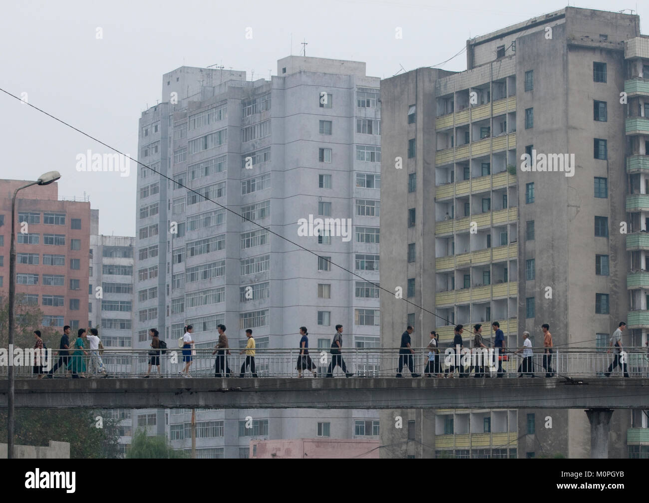 North Korean people crossing a bridge in the city center, Pyongan ...