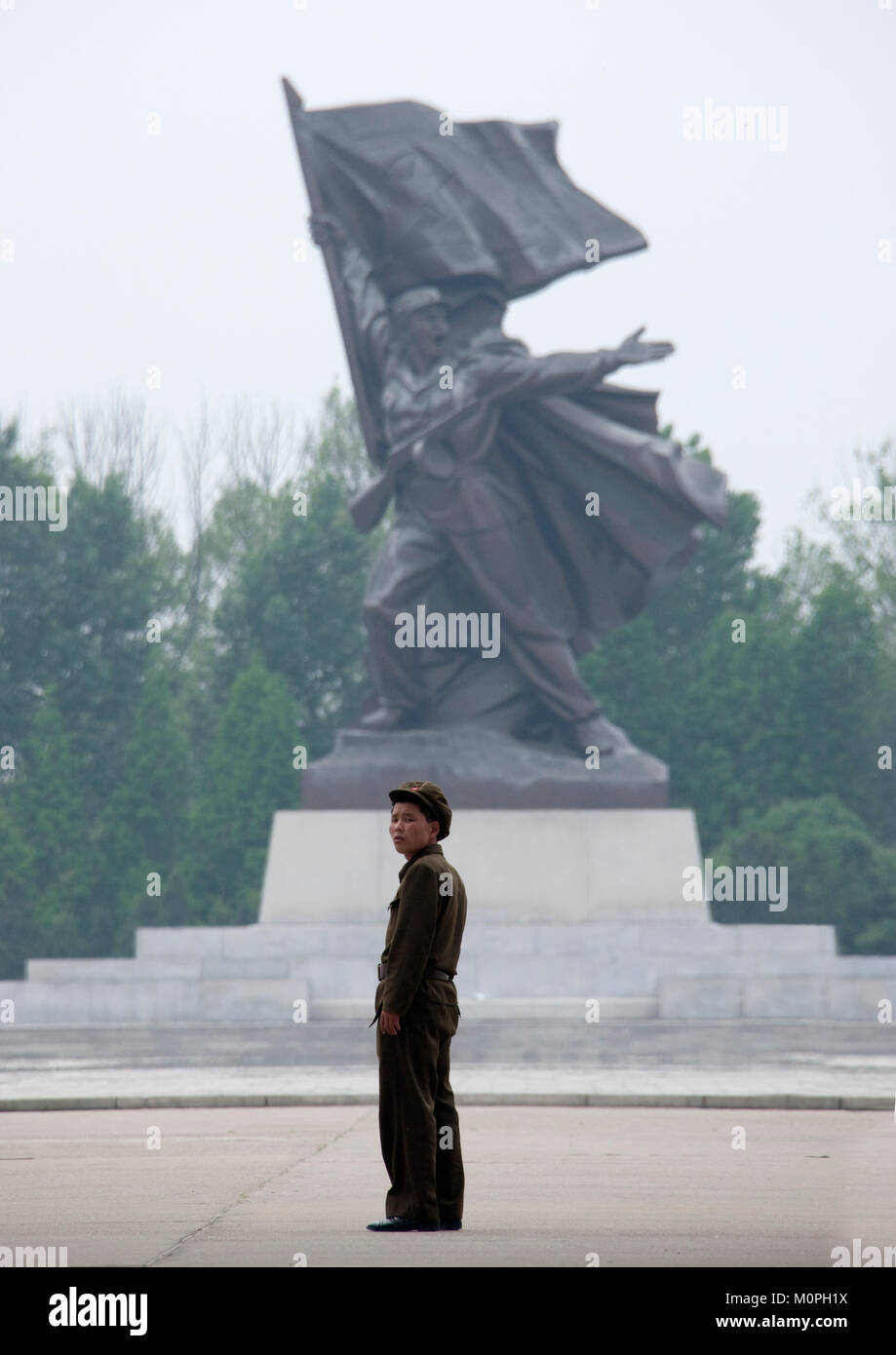 North Korean man standing in front of a sioldier statue, Pyongan ...