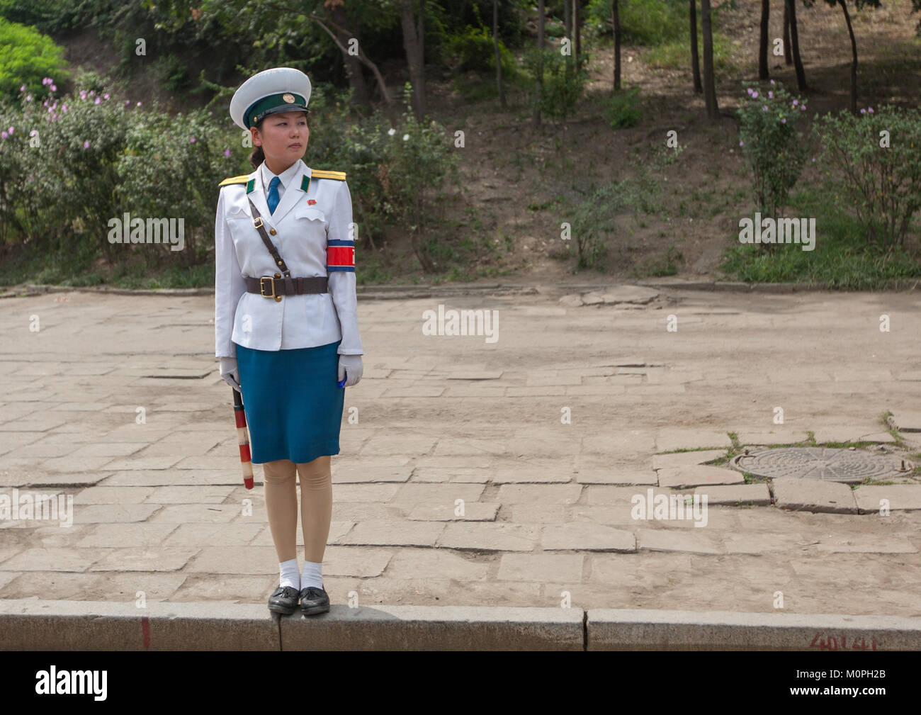 North Korean female traffic security officer in white uniform in the ...
