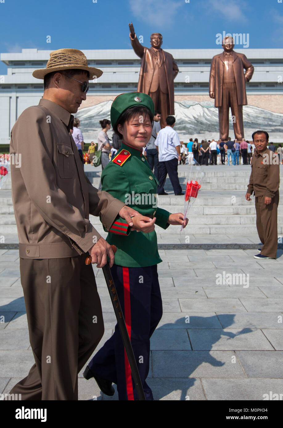North Korean blind man in front of the statues of the Dear Leaders in ...