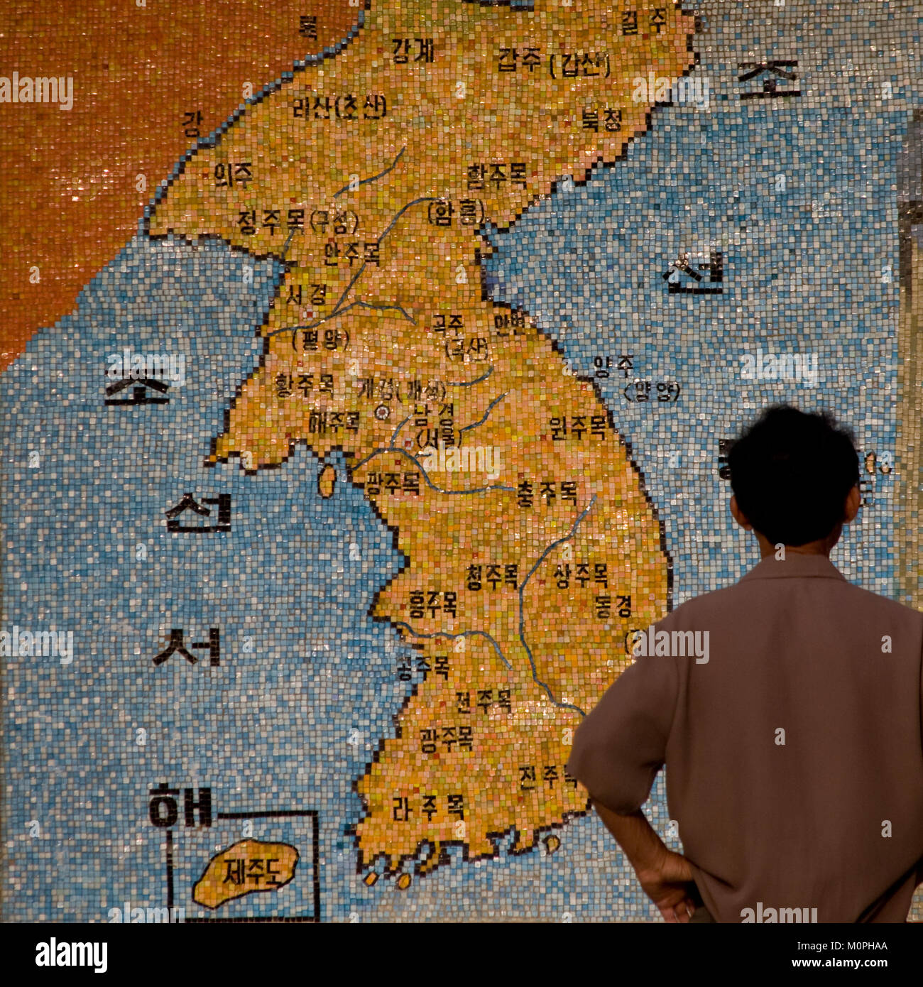 North Korean man looking a Korea map in the street, North Hwanghae ...