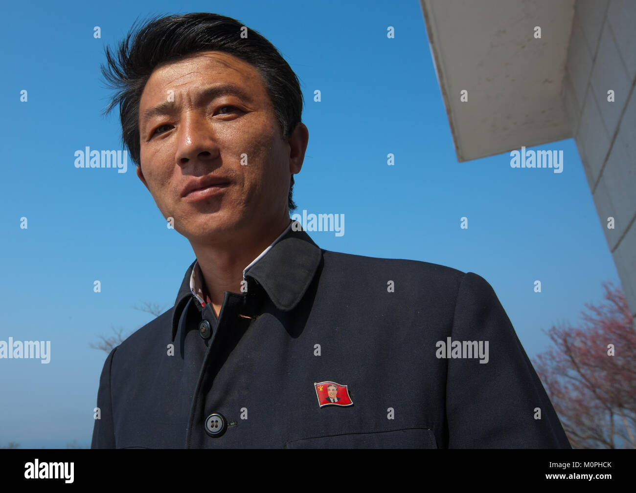 North Korean man with a workers' Party of North Korea with Kim il Sung ...