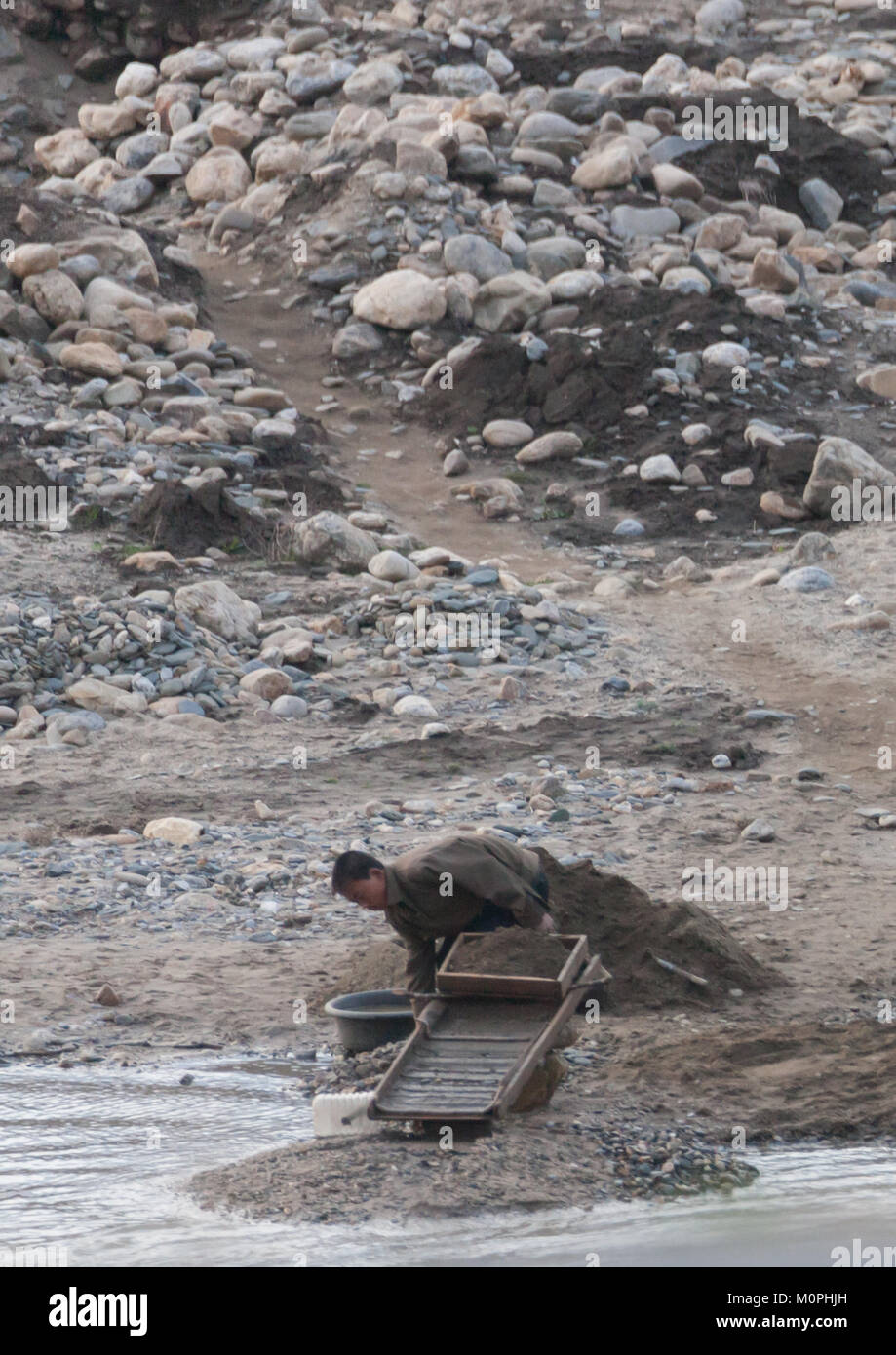 North Korean man panning for gold in a river, Kangwon Province, Wonsan ...
